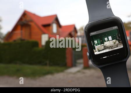 Home security system. Modern smartwatch with image of room through CCTV ...