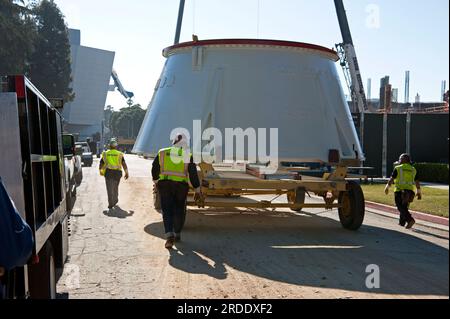 Workmen transporting one of the aft skirts of the Endeavor Space ...