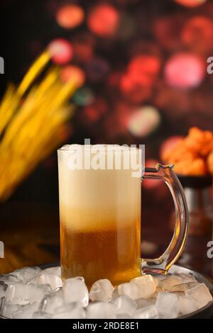 tulip glass with unfiltered draft beer on bar counter in the restaurant ...