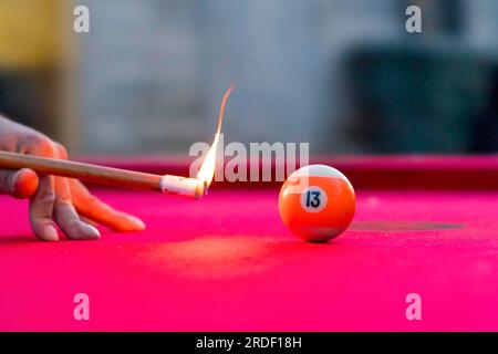 Billiard balls are photographed on fire while sitting outdoors in an ...