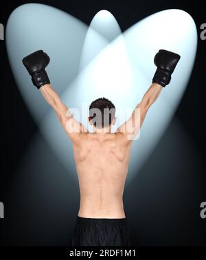 boxer standing with his back under the spotlight Stock Photo - Alamy
