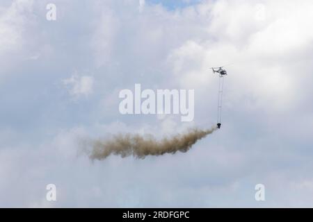 Symbolic image, climate change, helicopter, helicopter spreading finely ...