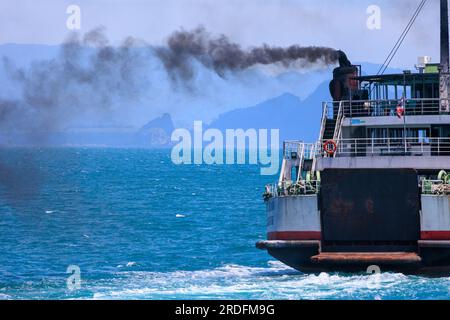 Ferry boat exhausting dark polluted smoke, Thailand Stock Photo - Alamy