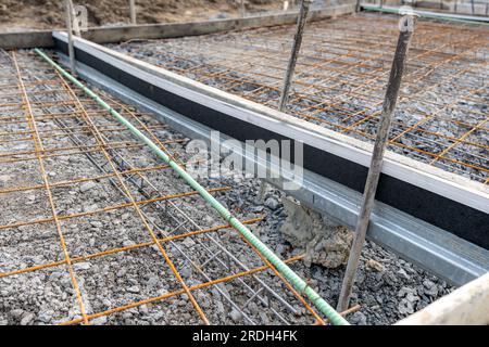 Welded wire mesh, WWM, installed within a sidewalk concrete form prior ...