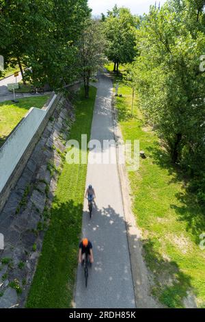 Cyclist on cycle path alongside the river Clyde in Glasgow, Scotland ...