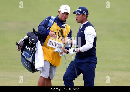 Shota Hayafuji, caddie for Hideki Matsuyama, of Japan, walks on the ...