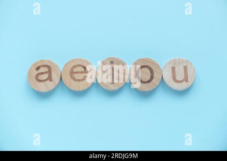 Learning english concept.Vowels of AEIOU on a blue background. Copy ...