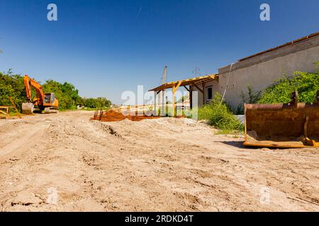 Excavator's work tool old rusty bucket, alfresco improvised warehouse ...