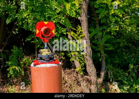 Part of leveler device on red metal pole ensures precise measurements ...
