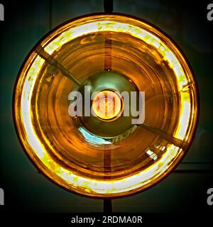 A circular LED light ring with a warm white glow, emitting a soft ...