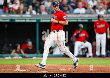 Cleveland Guardians' David Fry, left, follows through with his swing on ...