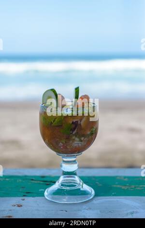 Shrimp cocktail with beach landscape in background. Blurred background ...
