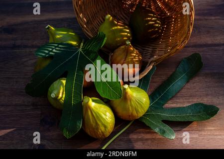 A few yellow figs on an brown wooden background in sunshine Stock Photo ...