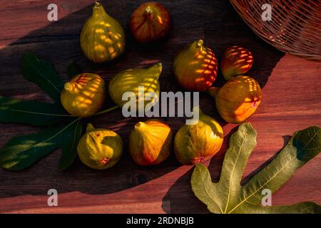 A few yellow figs on an brown wooden background in sunshine Stock Photo ...