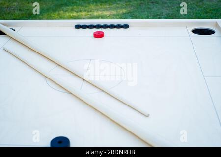 Novuss table with discs and cue stics Stock Photo - Alamy