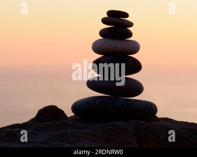 cairn at sunset, stones balances, pyramid of stones at sunset, concept ...