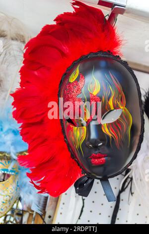 Impressive colorful carnival masks displayed on vendor stand in front ...