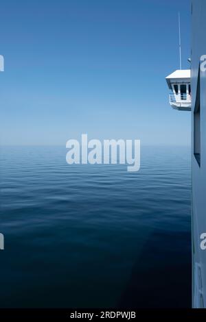 Wheelhouse or Bridge of a ship, viewed from the side. Quiet calm blue ...