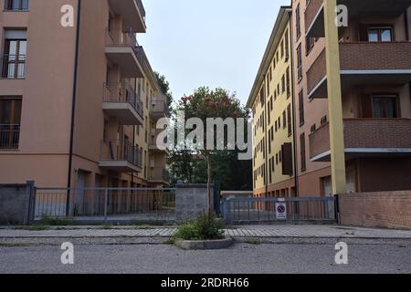 Gates and passageway between residential buildings seen from a street ...
