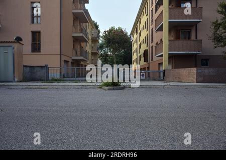 Gates and passageway between residential buildings seen from a street ...