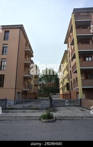 Gates and passageway between residential buildings seen from a street ...