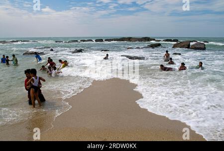Tourists bathing at the meeting point of three seas Bay of Bengal, Arabian Sea and Indian Ocean ...