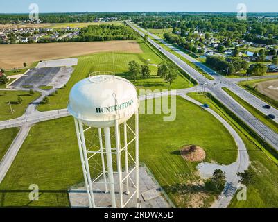 Close up aerial of Huntertown water tower with distant buildings and ...