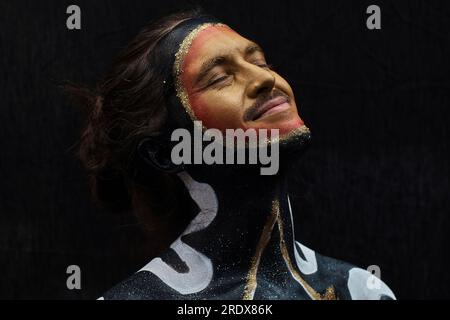 A model painted by an artist poses during at Human Connection Arts ...