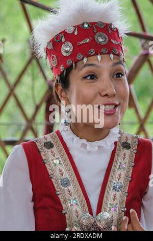 Young woman in traditional Kazakh dress with Takiya skull cap with ...