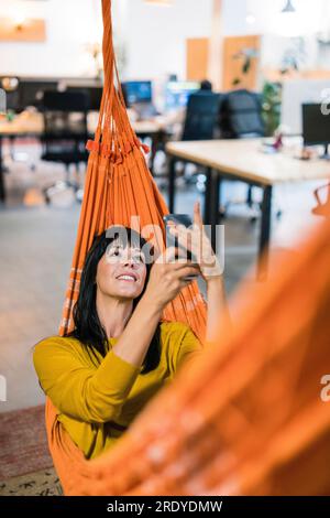 Smiling businesswoman using smart phone in car Stock Photo - Alamy