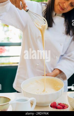Chef Mixing Batter With Wire Whisk In Bowl In Kitchen Stock Photo - Alamy