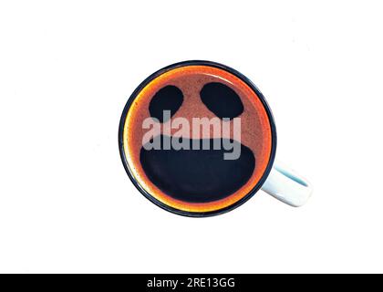 Pareidolia. Coffee cup with funny scream in fear face, top view. Open ...