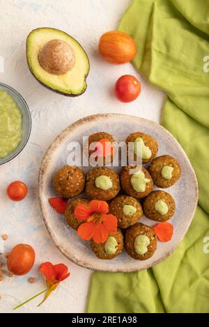 Falafel with guacamole on white concrete background. Top view, flat lay ...