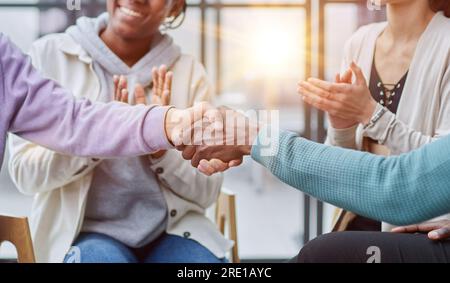 close up. smiling guy shaking hands with his friend Stock Photo - Alamy
