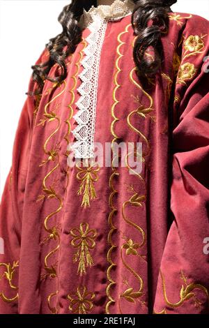 Cloak of red cloth with gold-coloured stitching. Trakai Castle and ...