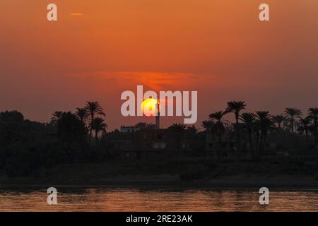 Sun setting behind minaret on the Nile Stock Photo - Alamy