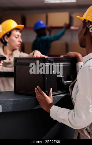 Warehouse managers preparing customer order and checking pick ticket on ...