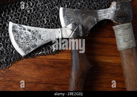 Medieval battle axes on chain mail armor background Stock Photo - Alamy
