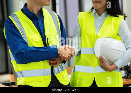 Civil engineers and architects handshake after work done at the office ...