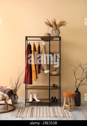 Interior of hall with shelving unit, clothes and shoes Stock Photo - Alamy