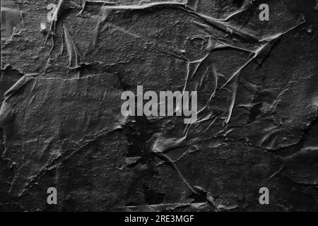 Peeled crumpled black poster paper texture background Stock Photo - Alamy