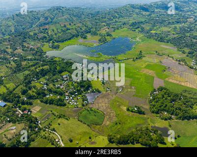 Drone survey of Lake Sebu surrounded by dry land, mountain forest ...