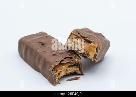 Chocolate bar with caramel inside on a white background Stock Photo - Alamy