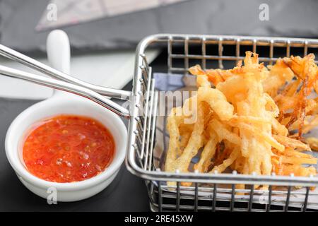 Vegetable tempura served in a frying grate. Taro and carrot tempura ...