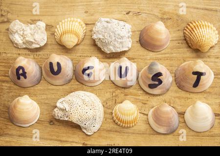 concept of august and holidays with the inscription on seashells Stock ...