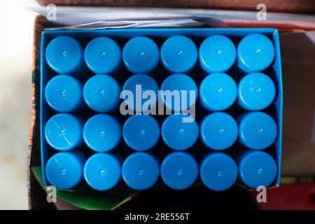 Glue in package. Many packs of glue. Blue Objects. Jars of substance ...