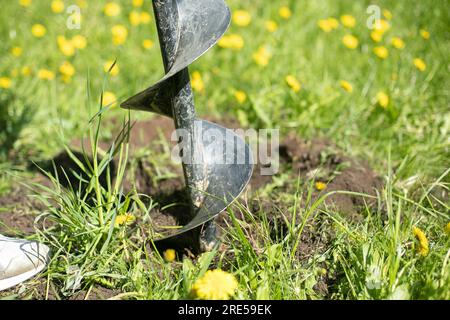 Drill for digging up earth. Planting tool. Excavated soil. Drill bit ...