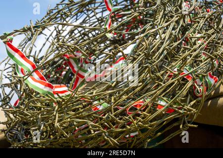 Barbed wire painted green with a ribbon in the Hungarian national color ...