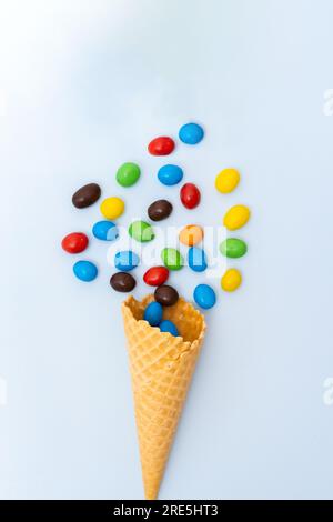 multicolored candy with a waffle cone on a blue background Stock Photo ...