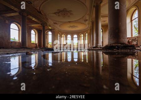 Flooded large hall with columns in old abandoned mansion, water ...